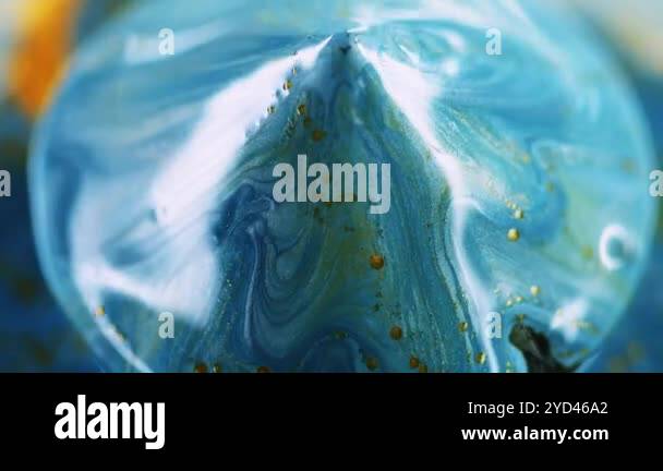 Shimmering fluid gem. Varnish pouring. Defocused blue golden yellow ...