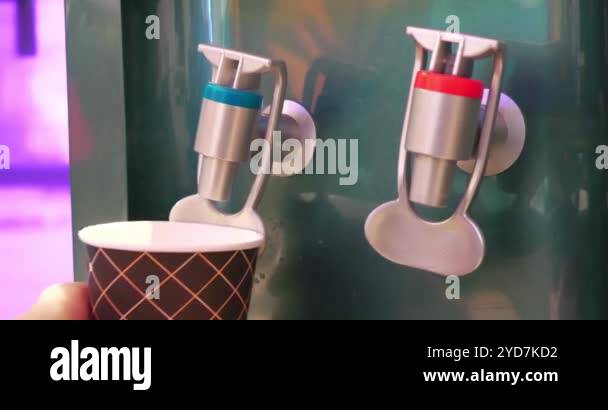 Office employee using water cooler to drink. Male hand holding paper ...