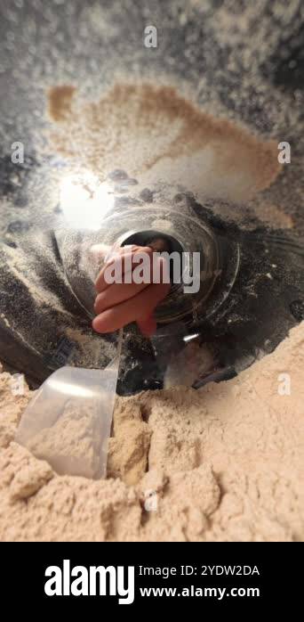 Vertical video. Zoom in, View from inside a Protein Powder Jar, a Man ...