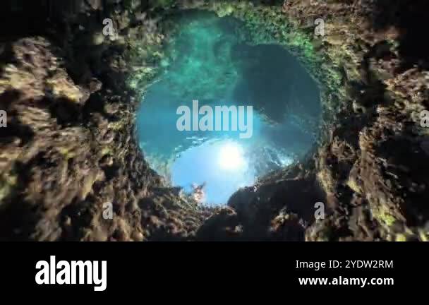 Underwater cave view from below, looking up toward the surface, where ...