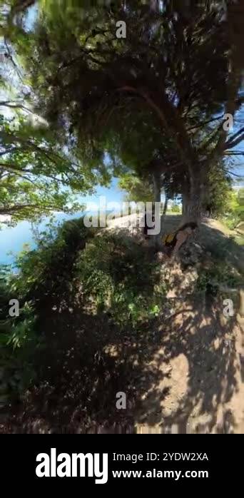 Vertical video. Tiny Planet perspective of a young man and woman ...