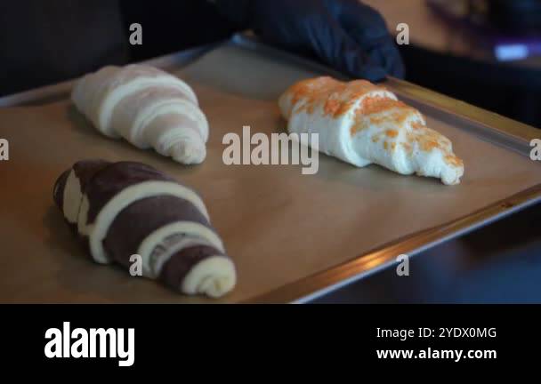 Croissants bake inside the oven, puffing up with a golden finish. A ...
