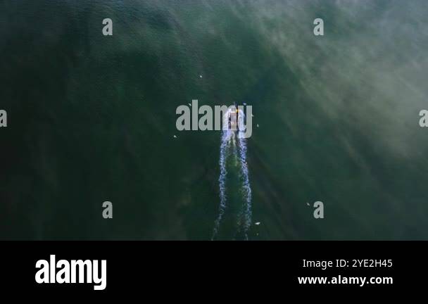A stunning aerial view showcases a boat peacefully floating on the ...