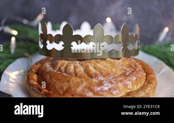 One royal galette with a golden crown on top lie on a gray background ...