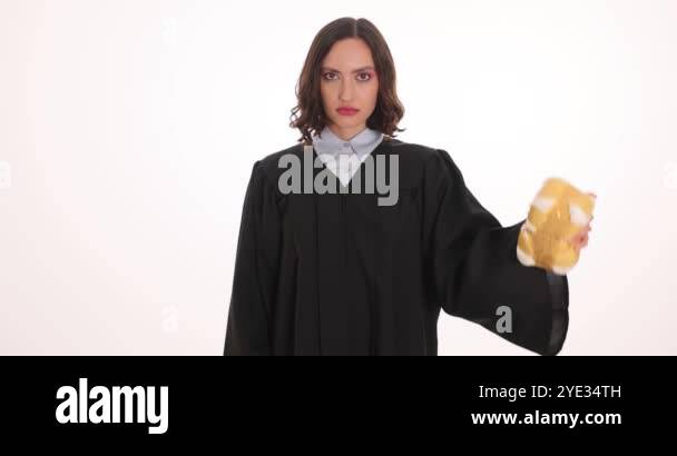 Female judge holds handcuffs and narcotics pack on white background ...