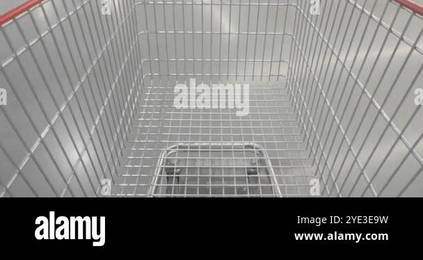 cart moves forward in the supermarket, empty shopping trolley, trolley ...