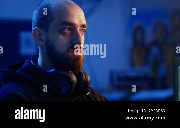 Hacker hiding in underground bunker, looking over his shoulder and ...