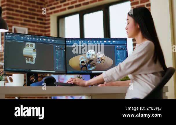 Asian professional engineer works on coding industrial designs using advanced software tools ...