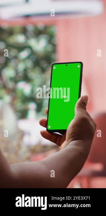 Vertical Video Young artist looking at isolated chroma key display in ...