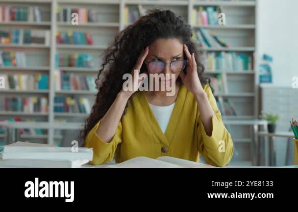 Tired Latino Arabian woman student preparing exam read book university ...