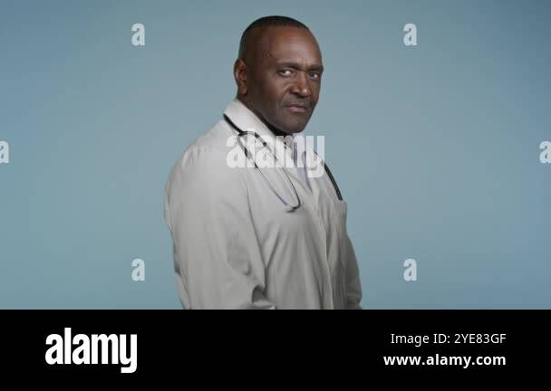 African american man doctor male physician turning to camera smiling ...