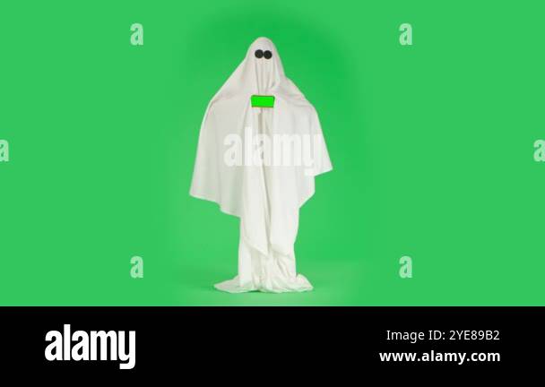 Person dressed as ghost posing at camera. Halloween ghost in white ...