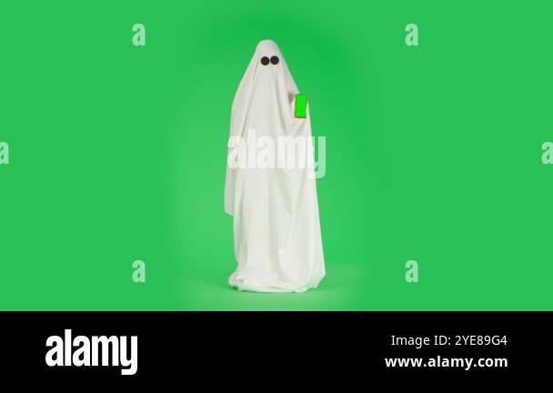Person dressed as ghost posing at camera. Halloween ghost in white ...