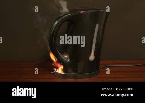 Electric kettle on fire, flames and sparks, black smoke. Cause of fire in the flat, short ...