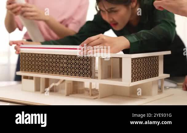 Home designer using architectural equipment review and measure architectural house model design ...