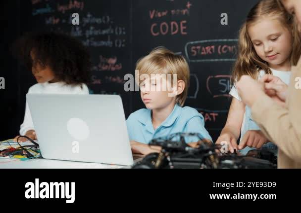 Closeup of boy using laptop programing engineering code and writing ...