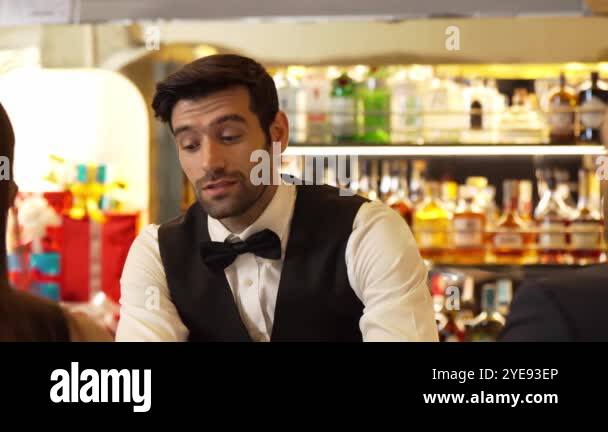 Good looking bartender warm smiling friendly conversation with couple ...
