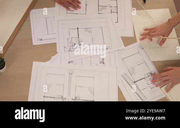 Slow motion interior designer drafting blueprint with customer ...