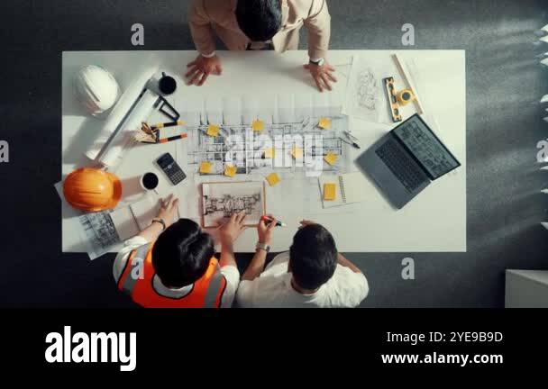 Top down aerial view of smart architect engineer team pointing and ...