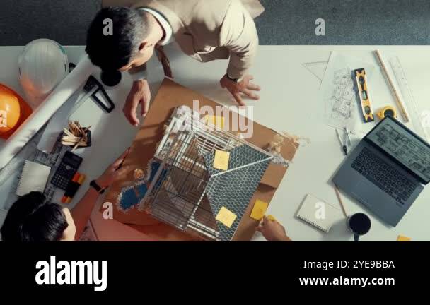 Top down aerial view of architect writing sticky note and placed at ...