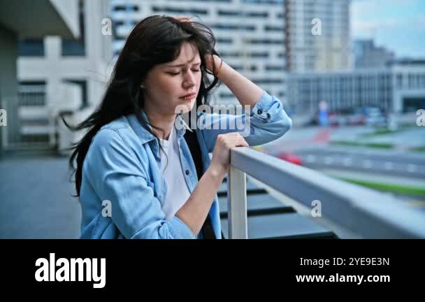 Worried nervous crying young woman, outdoor modern city background. Sad ...