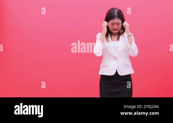 young indonesia woman wearing formal white suit sad, crying both hands ...