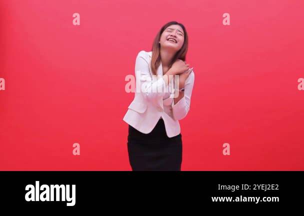 female wearing formal white suit massaging her painful shoulder, both ...