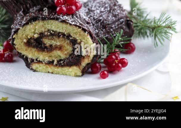 Buche de Noel, Chocolate Christmas Yule Log. Christmas light on a white ...