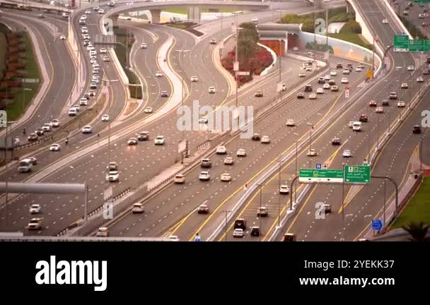 An aerial view shows a busy highway with many vehicles and various road ...