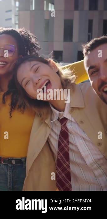 Vertical. Laughing group of young diverse friends looking joyful at ...
