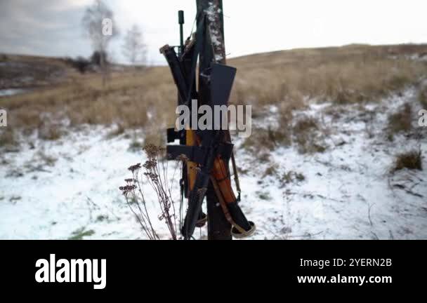Various firearms hang on a pole. Automatic weapons. Grenade launchers ...