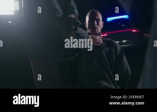 Intense night scene showing confrontation between police officer and ...