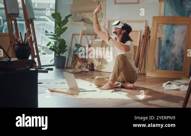A Male Artist Paints in Virtual Reality Using VR Glasses, Exploring New ...