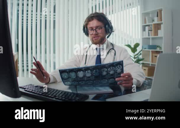 A Doctor Works, Analyzing X-rays and CT Scans on a Computer Screen He ...