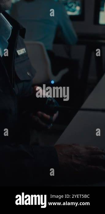Vertical tilting closeup of middle-aged African American security guard ...