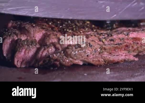 In this close-up video, watch as a chef expertly slices tender, grilled ...