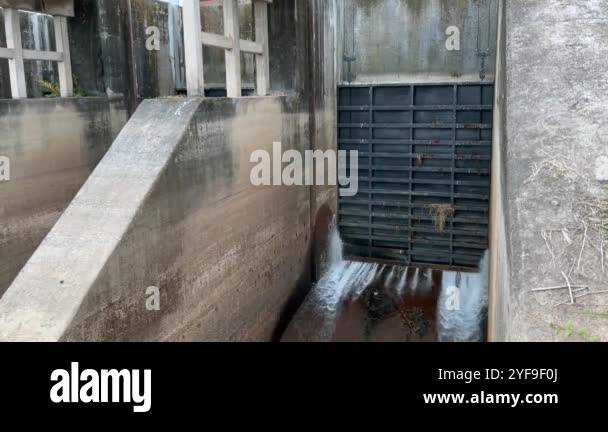 spillway gate of a concrete dam. This industrial structure channels ...
