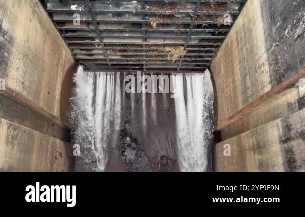 spillway gate of a concrete dam. This industrial structure channels ...