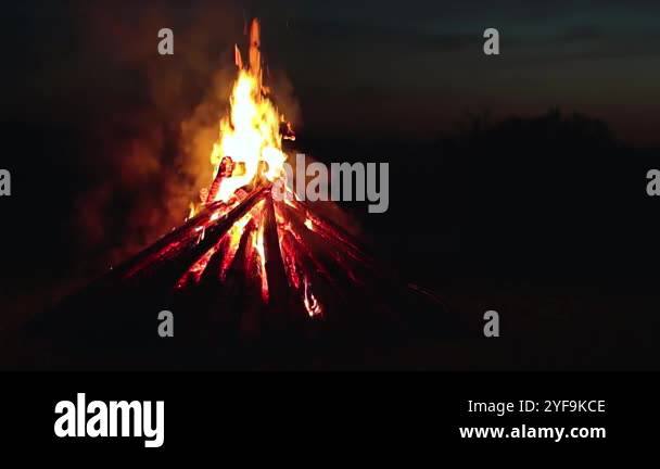 Big Burning Campfire at Summer Night against the Blue Sky. Wood on Fire ...