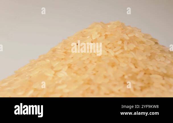 Dry Uncooked Parboiled Rice Heap Rotating against White Background. A ...