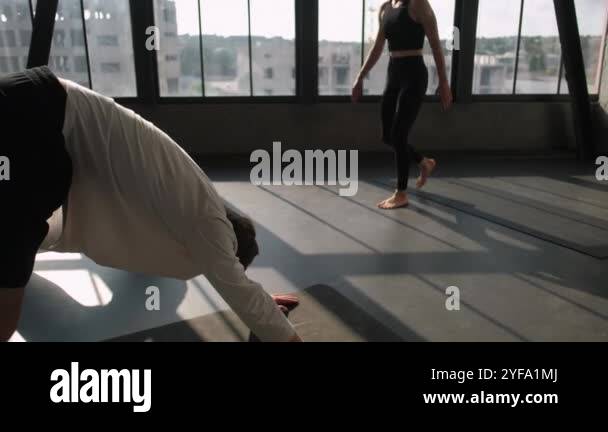 Sport class. Yoga studio. Group people training stretch downward facing dog asana on mat with ...