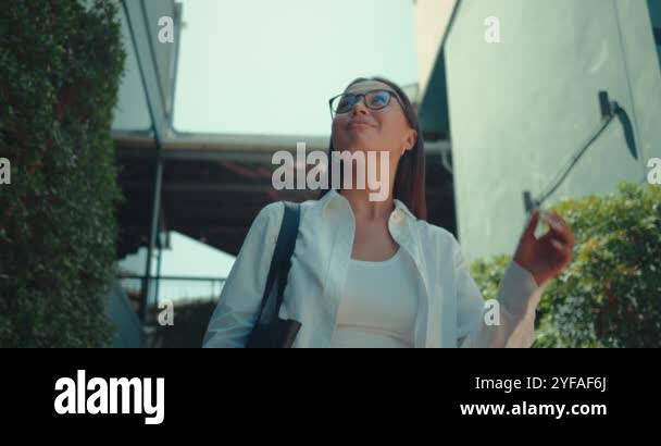 Woman standing in middle of bustling city and looking around urban ...