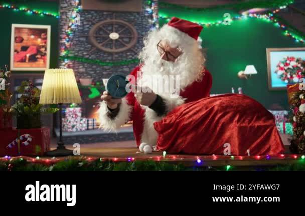 Santa Claus showcasing the Christmas eve with a wall clock in his log ...