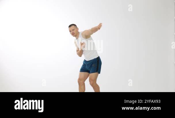 Man demonstrates dance exercises on white background. Young man doing ...