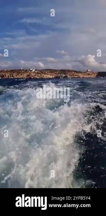 Watch the beauty of waves trailing behind a boat as it moves steadily ...