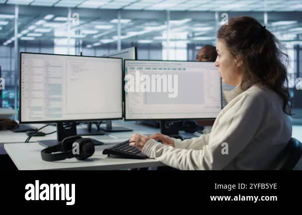 IT professional in server hub ensuring valuable data remains shielded from potential threats ...