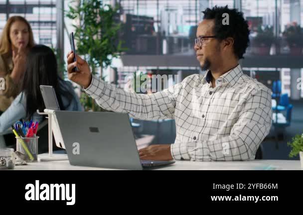 General manager takes a break and snaps some photographs in a corporation, working on business ...