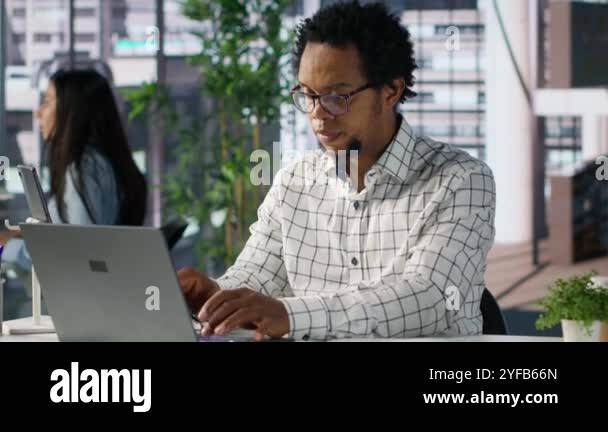 Skilled businessman at his office desk working on report writing, data analysis and deadline ...
