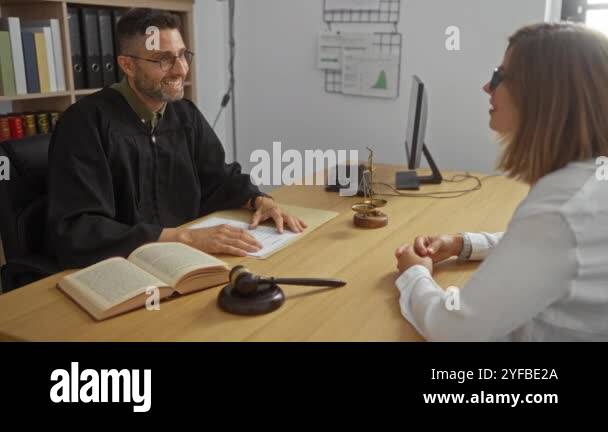 Judge talking to smiling female client in office shaking hands with ...