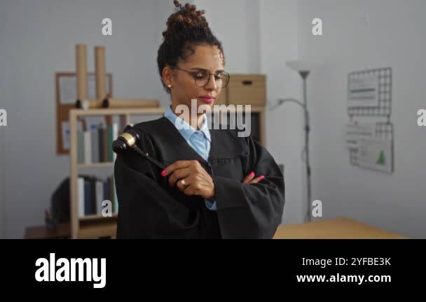 Female judge with glasses and curly hair stands confidently with ...